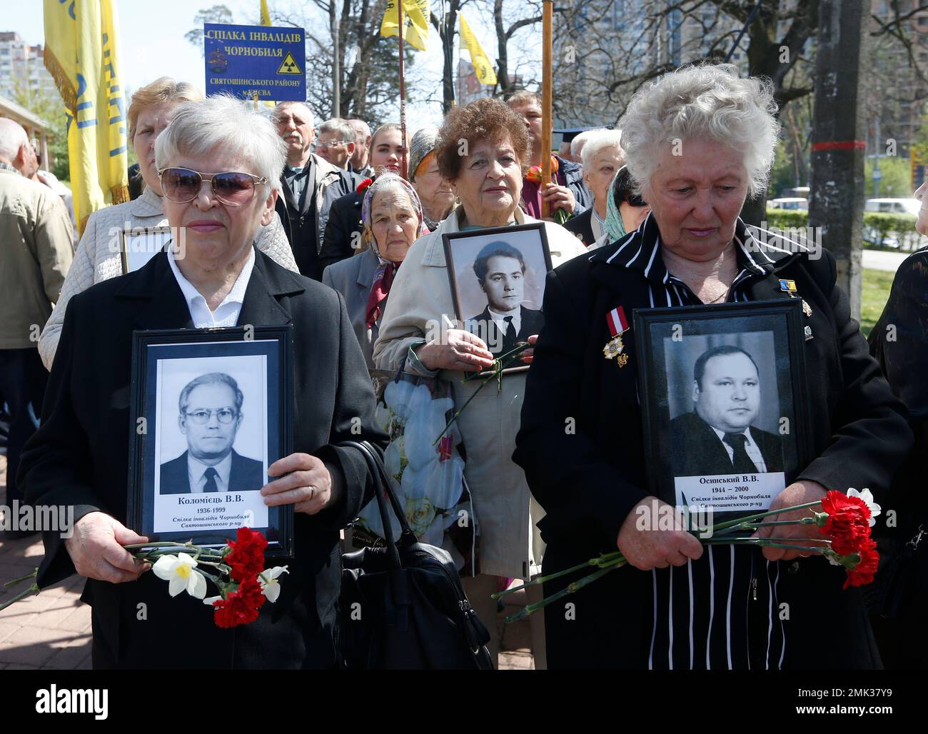 Widows of Chernobyl victims hold portraits of their husbands who died ...