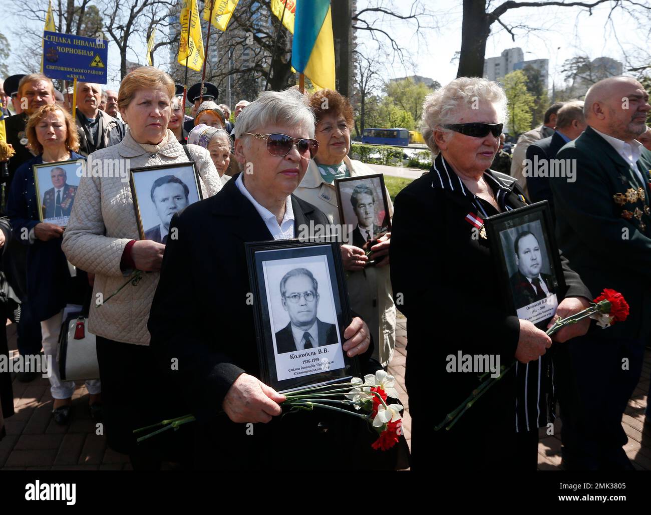 Widows of Chernobyl victims hold portraits of their husbands who died ...