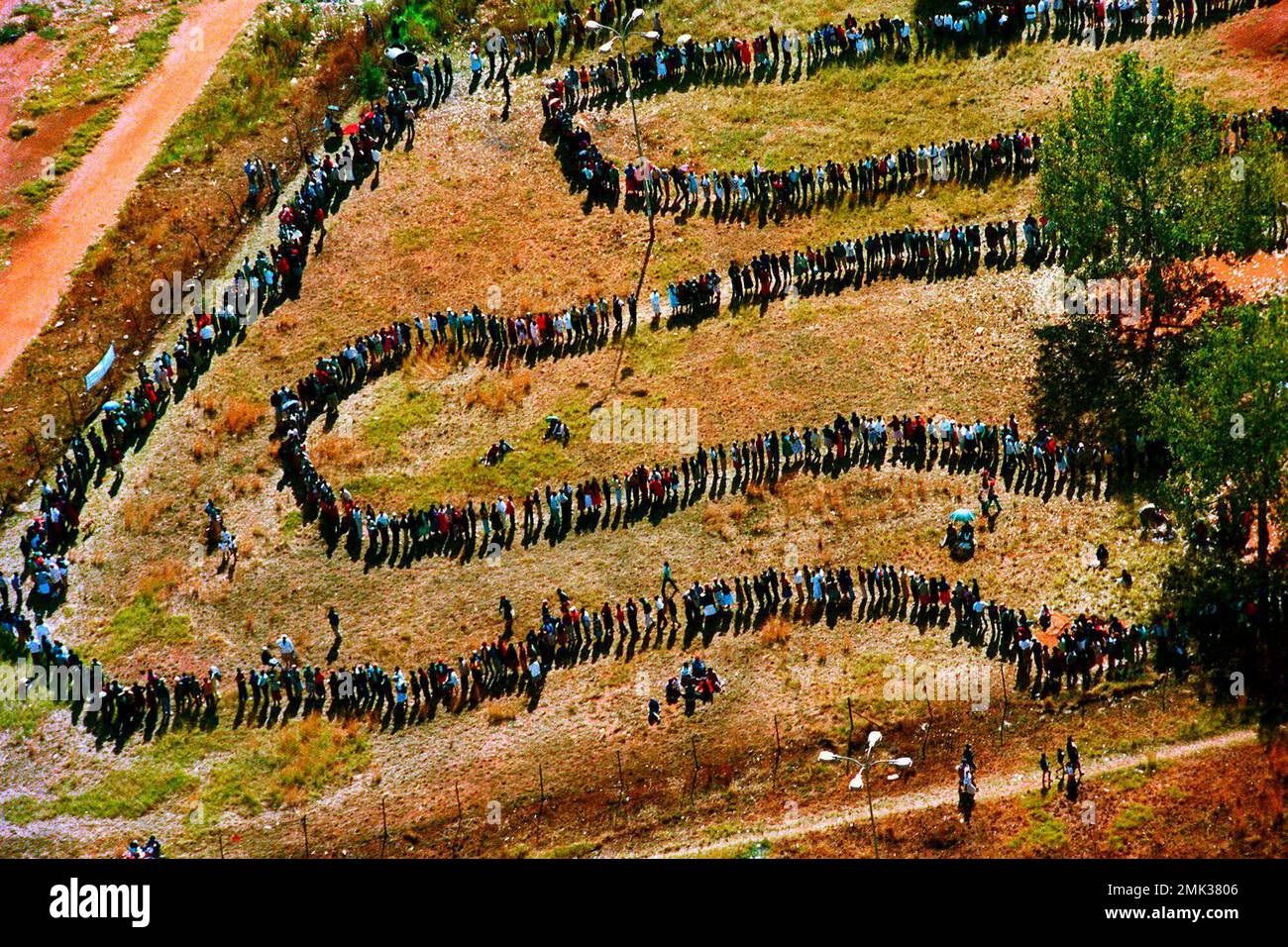 FILE - In this April 27, 1994, file photo, people queue at a primary ...