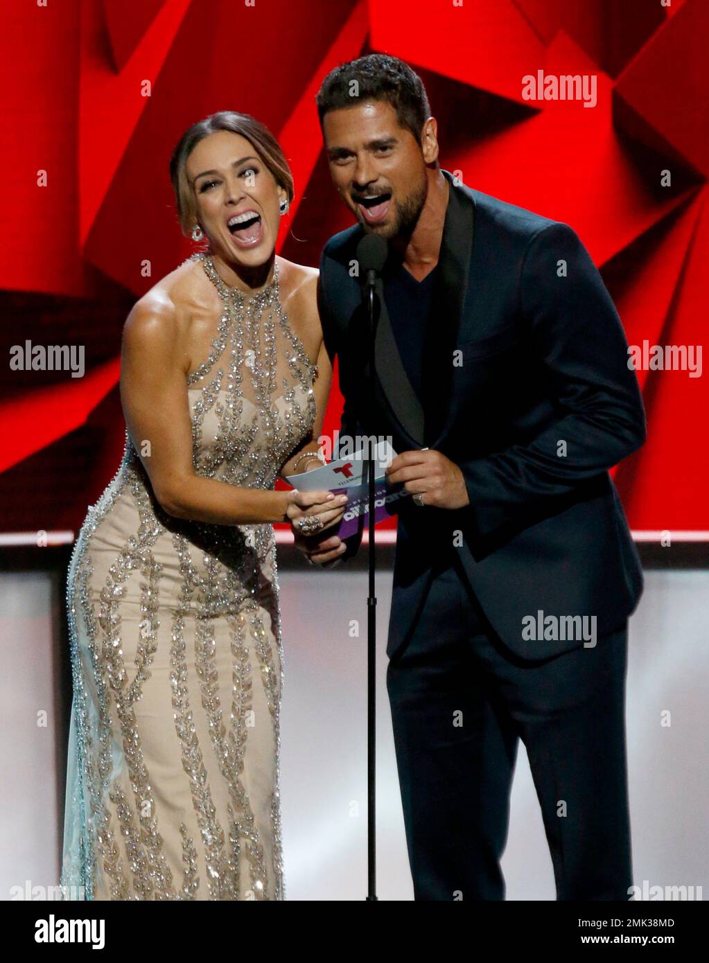 Jacky Bracamontes, left, and J.R. Ramirez present the award for artist ...
