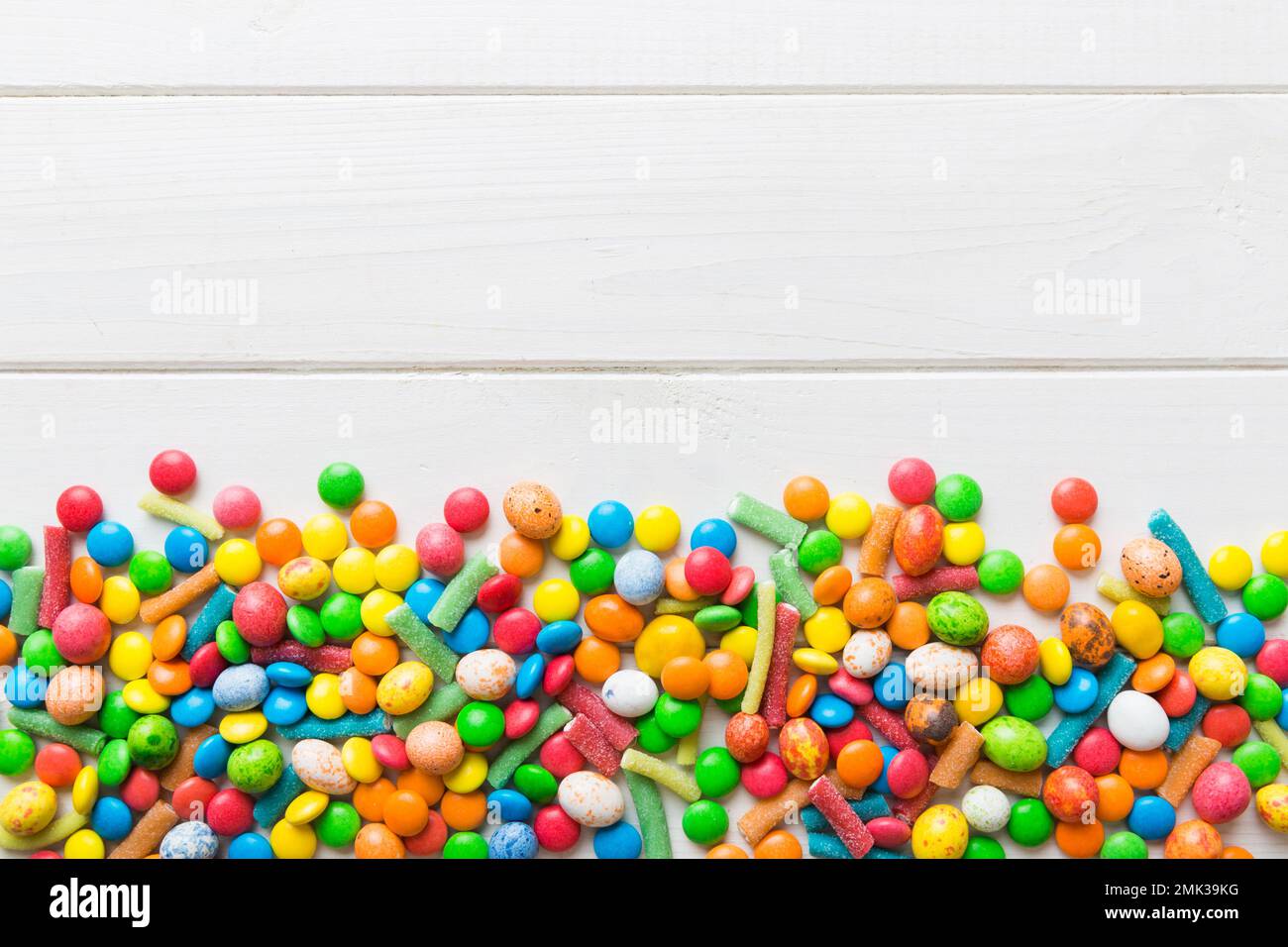 Mixed collection of colorful candy, on colored background. Flat lay ...
