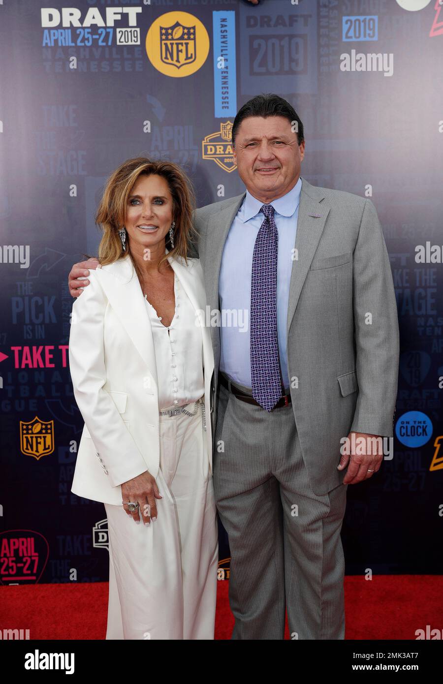 Louisiana State head coach Ed Orgeron and his wife Kelly walk the red carpet ahead of the first ...