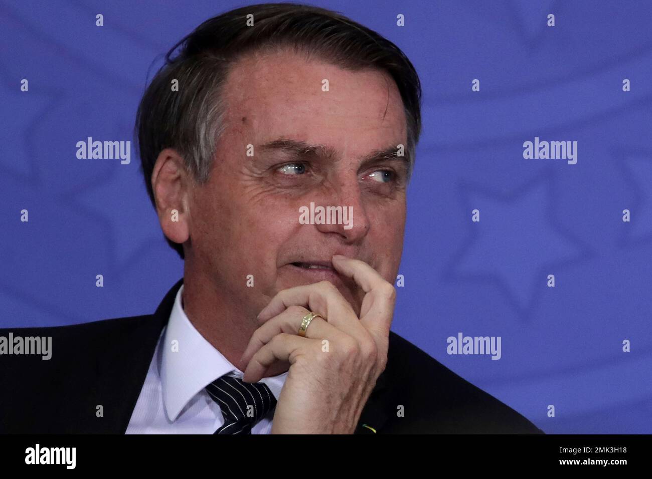 Brazil's President Jair Bolsonaro smiles before signing the law that ...