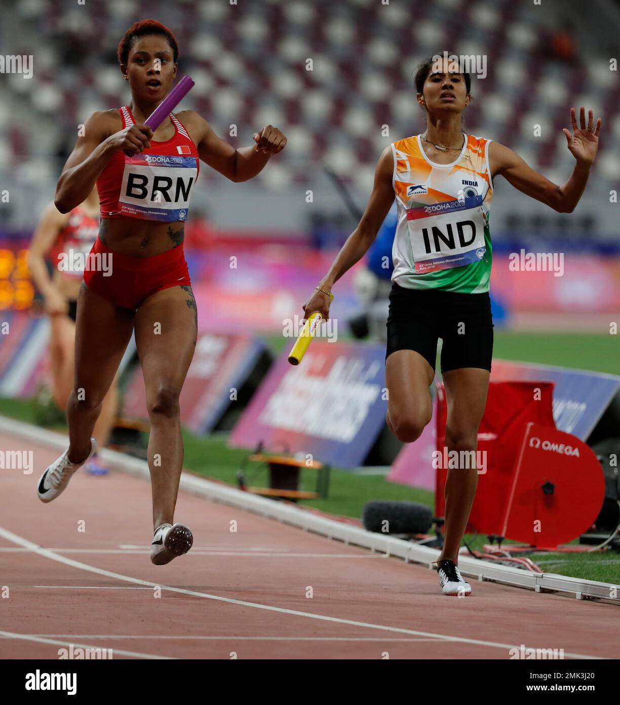 Athletes from India and Bahrain compete in the 4x400 relay final at the ...