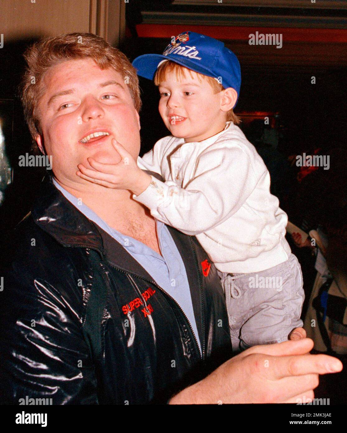 New York Giants' lineman Bart Oates is greeted by his son Derek, 3, as ...