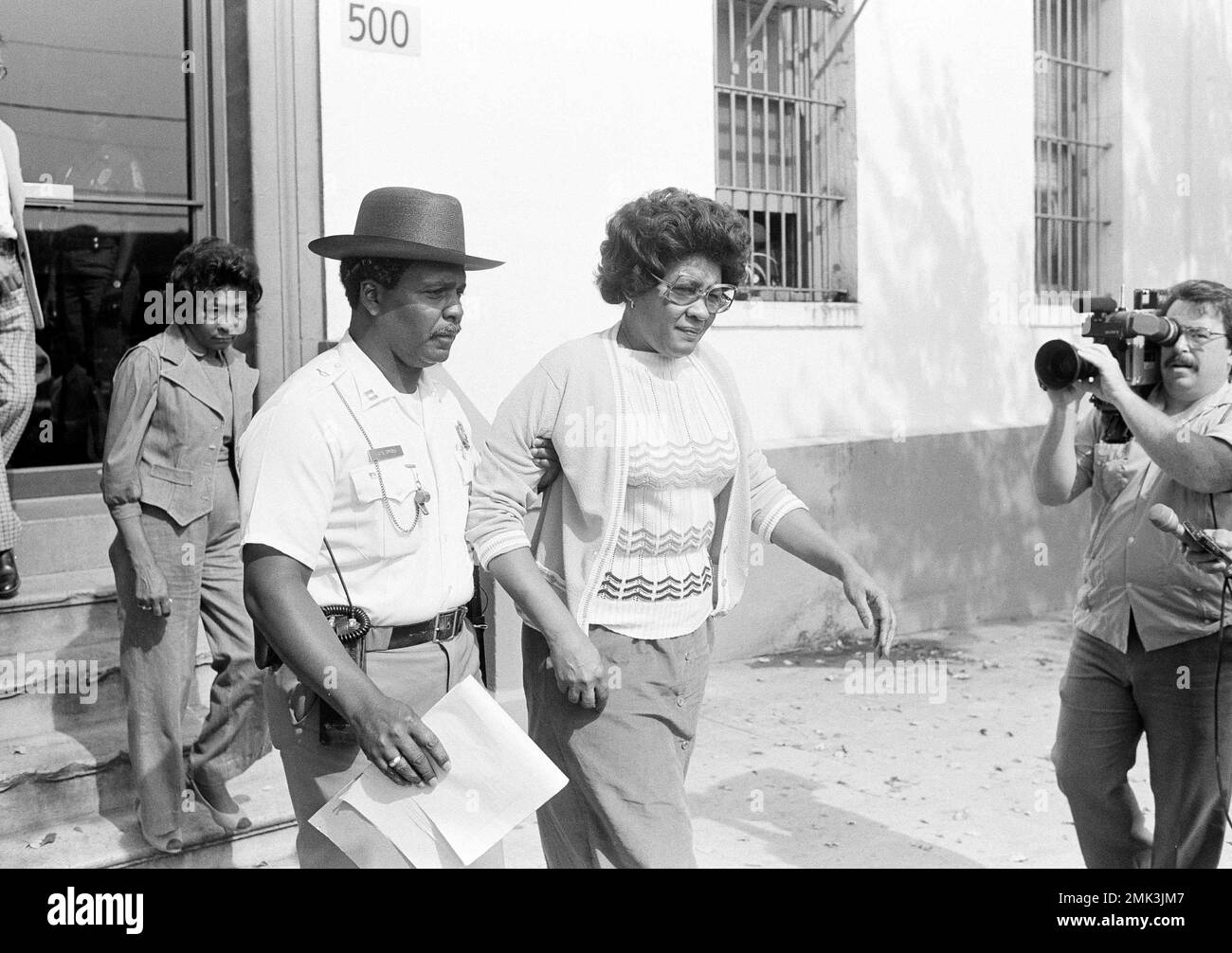 Bertha Briley, right, mother of Linwood Briley, is escorted from the ...