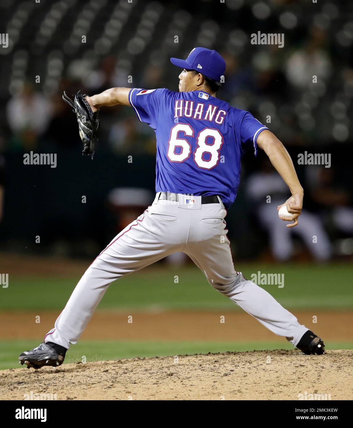 In his MLB debut, Texas Rangers pitcher Wei-Chieh Huang works against the Oakland Athletics in ...