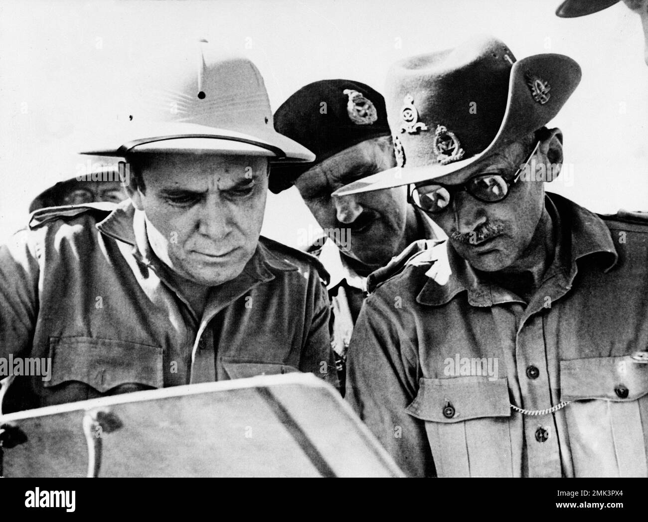Wendell Willkie, left, insects a map with Lieutenant Gen. Bernard L ...