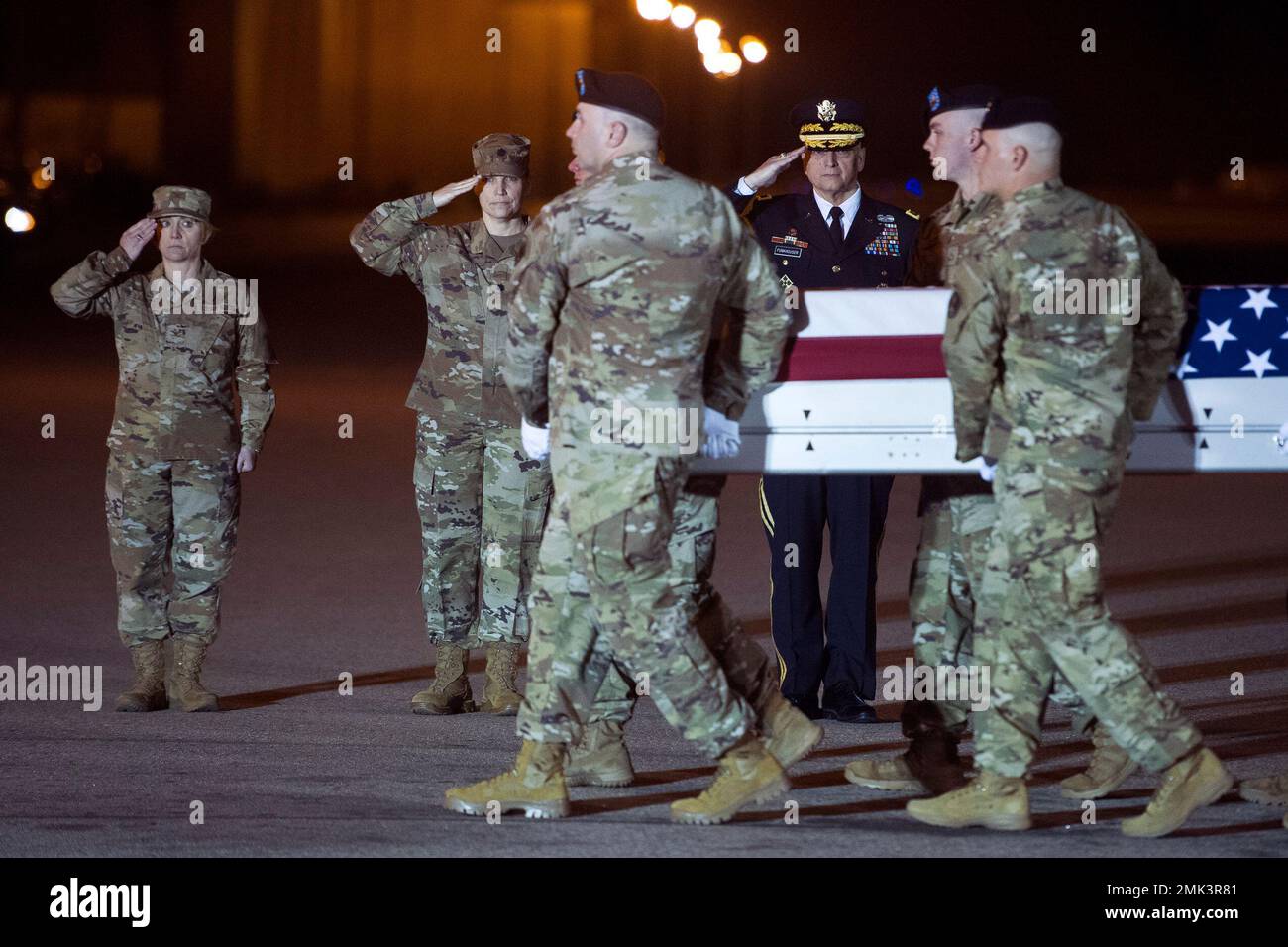 An Army carry team moves a transfer case containing the remains of Spc ...