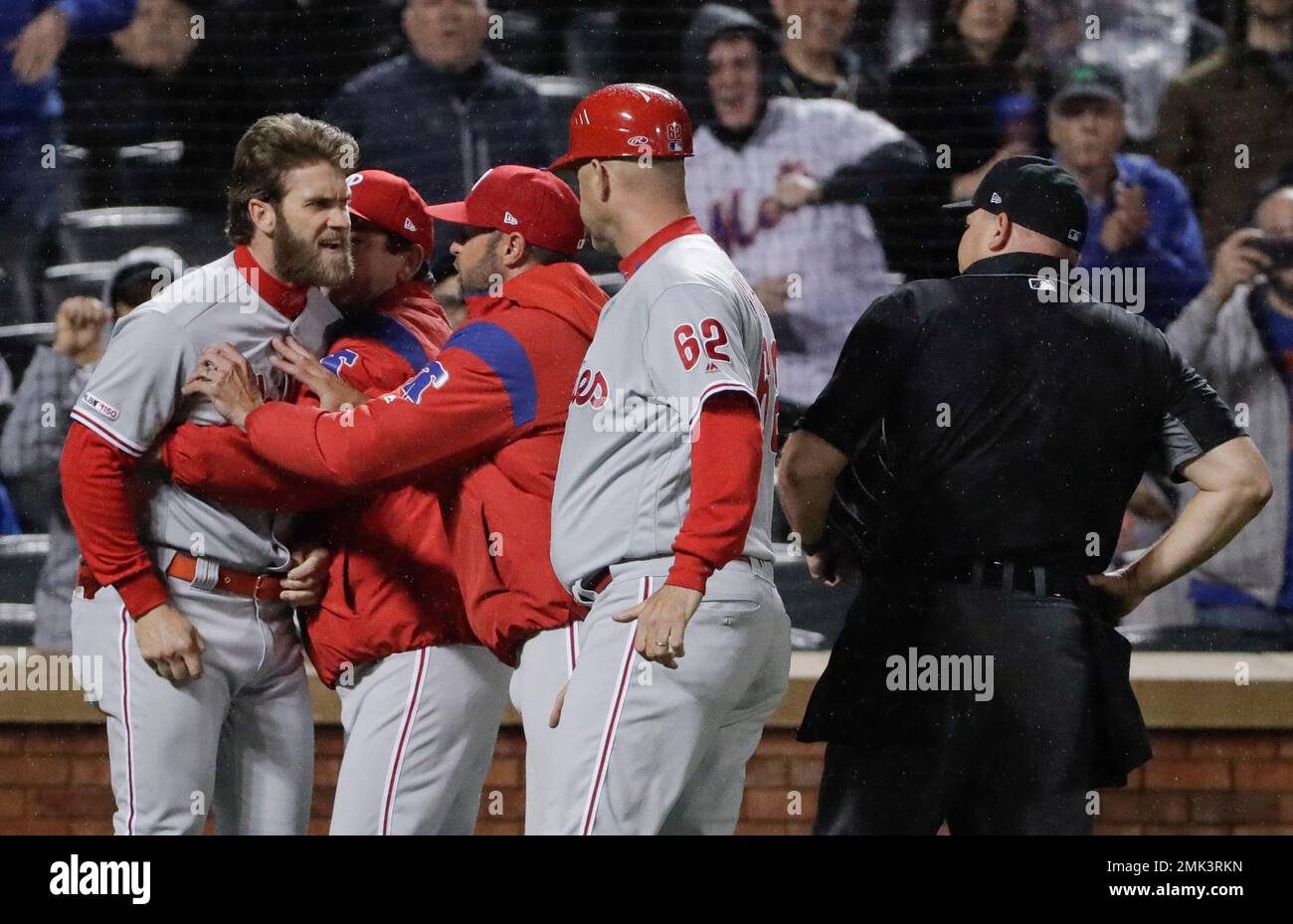 Philadelphia Phillies' Bryce Harper, left, is restrained while arguing ...