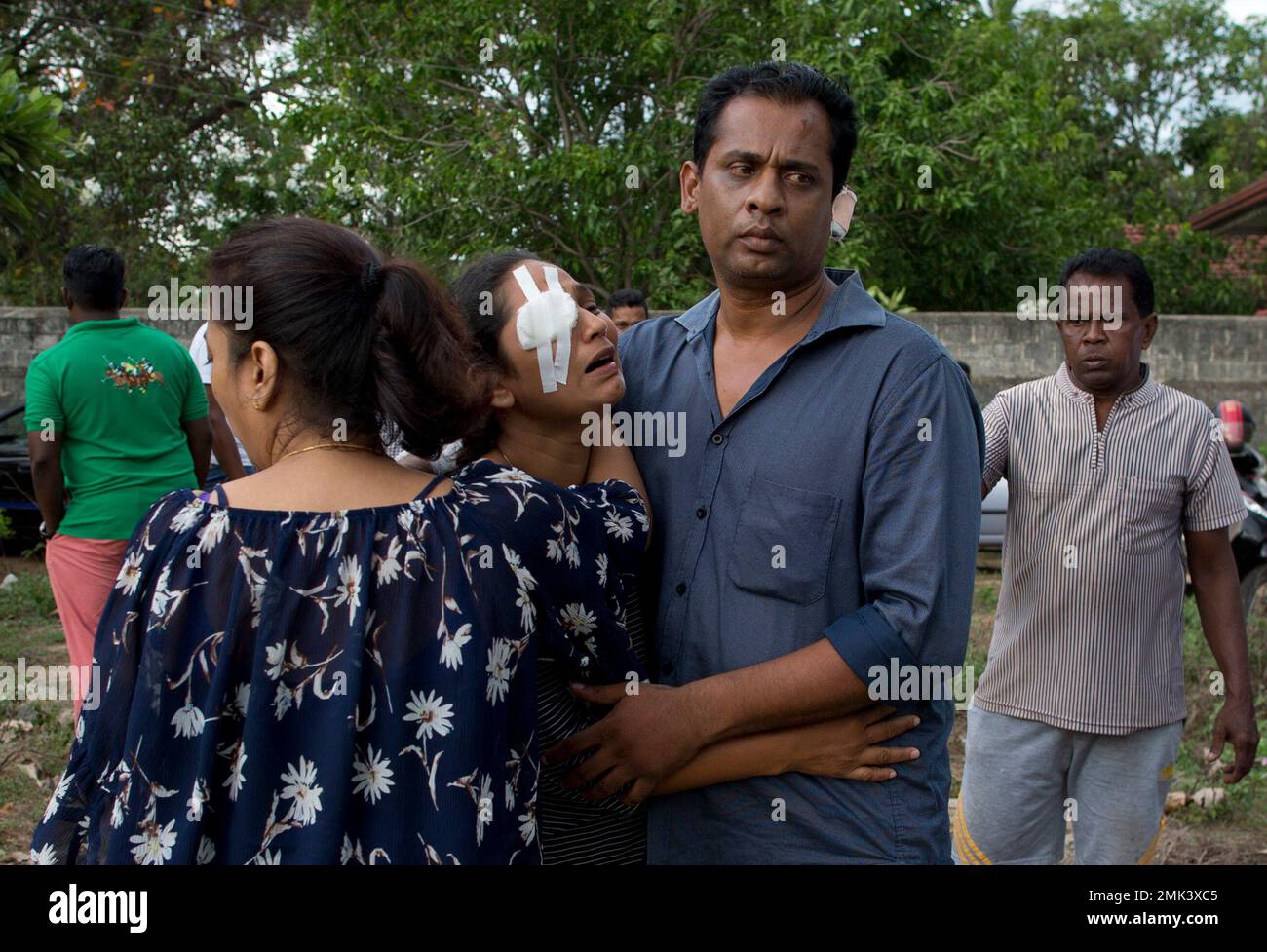 Delani Fernando, center and her husband Randima Fernando mourn the ...