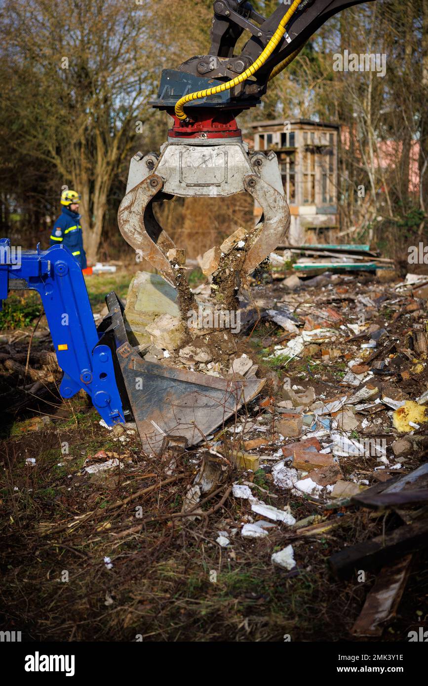 Members of THW remove construction debris with the help of a wheeled ...