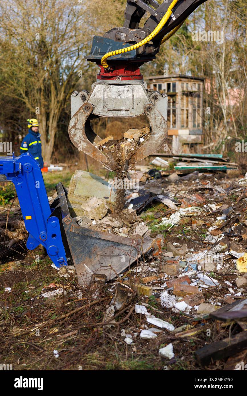 Members of THW remove construction debris with the help of a wheeled ...