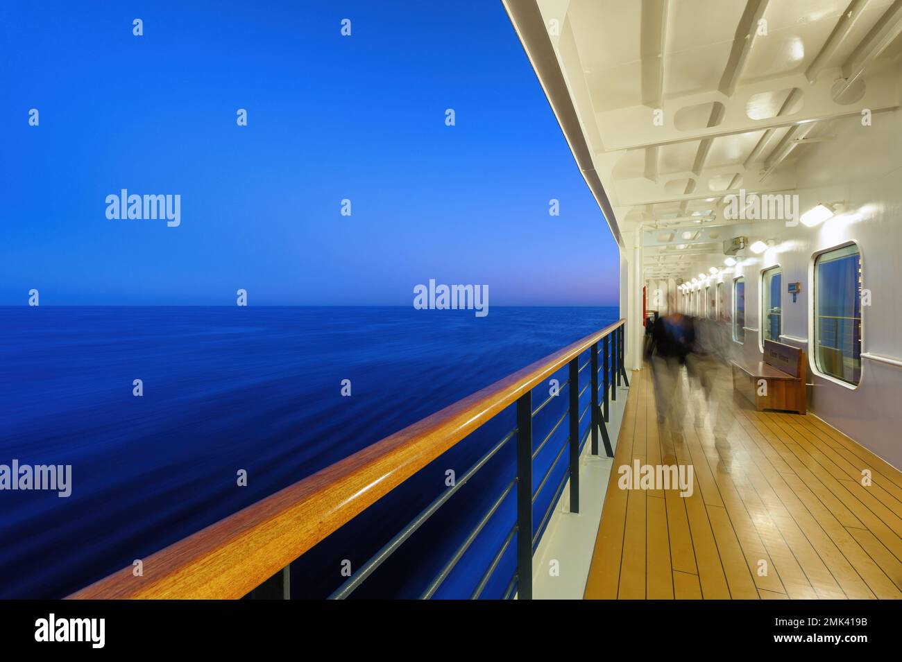 A view of passengers walking on the promenade deck of a cruise ship at ...