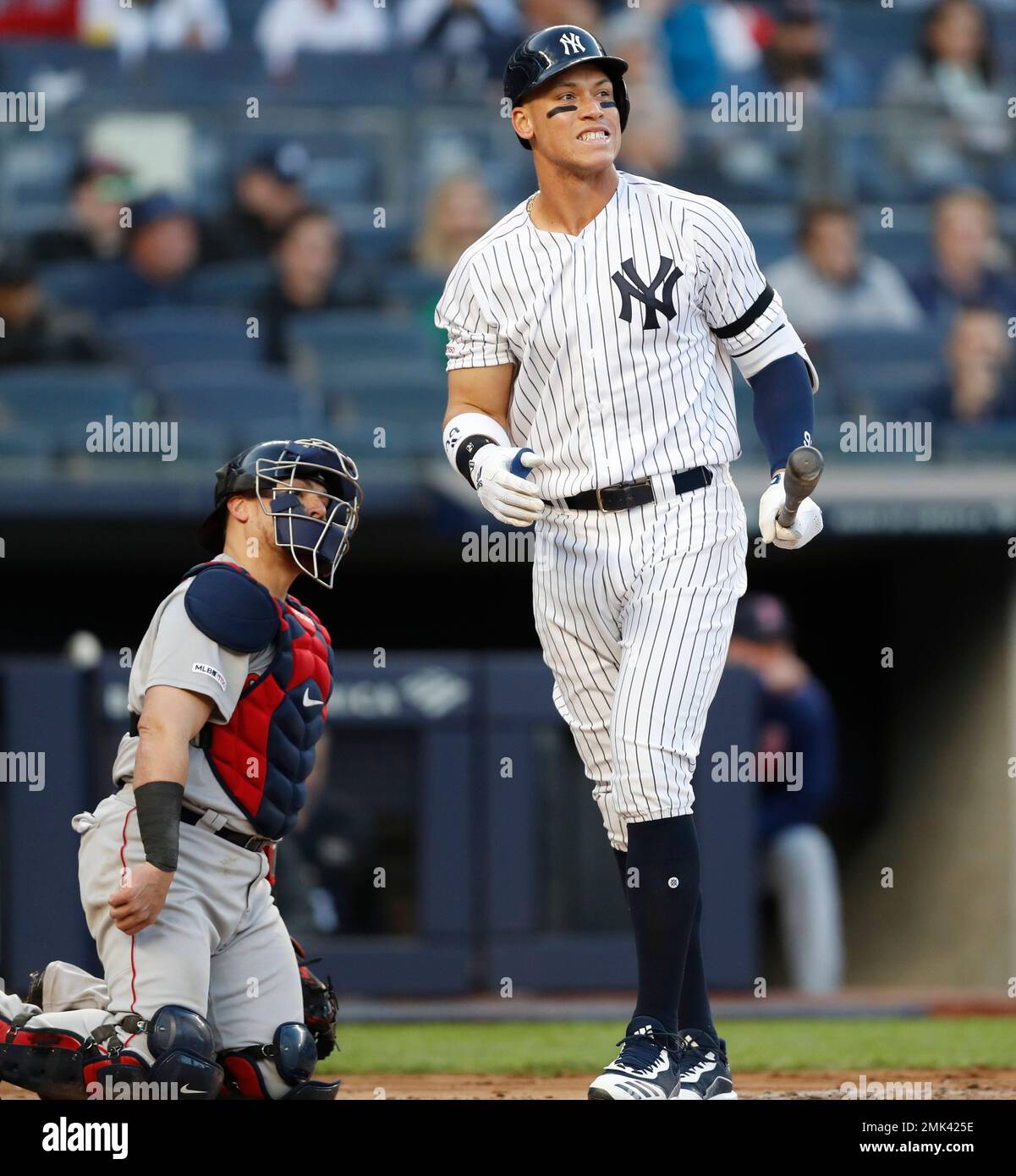Boston Red Sox catcher Christian Vazquez, left, peers around New York ...