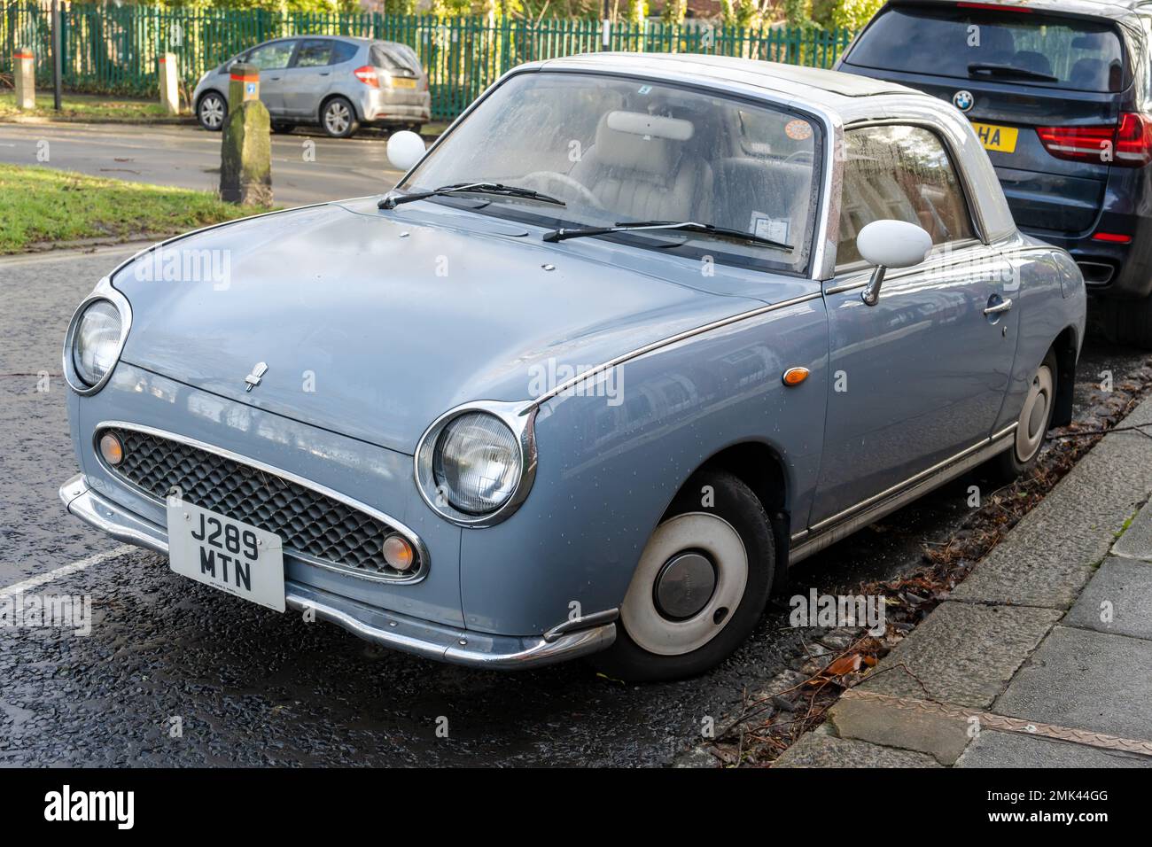 A Nissan Figaro, a rare and classic 1991 car, in the UK, parked in the ...
