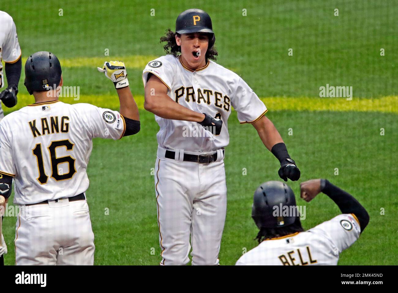 Pittsburgh Pirates' Cole Tucker, center, celebrates as he returns to ...