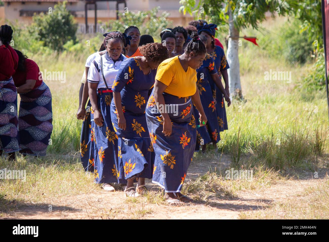 Women dancing and singing dressed in colorful traditional African wax ...