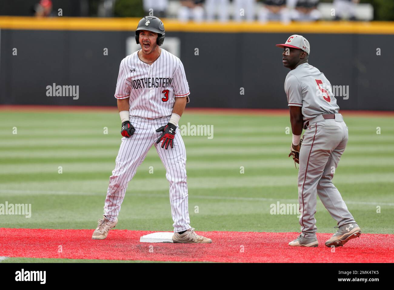 Northeastern's Jake Rosen (3) celebrates a double as Charleston's ...