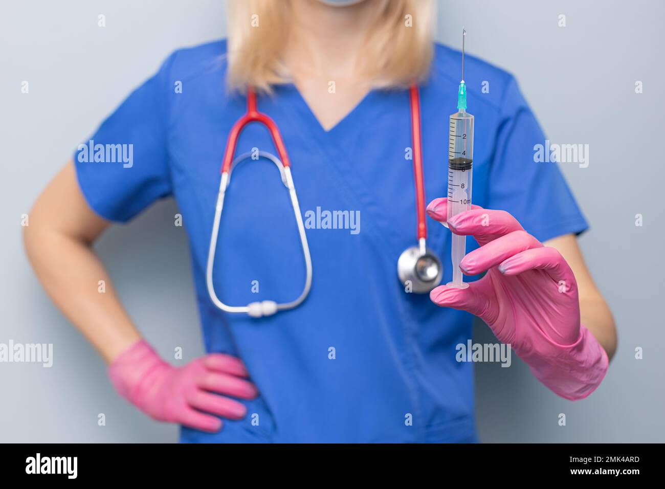doctor holding a syringe with medicine in his hand. doctor holding a ...