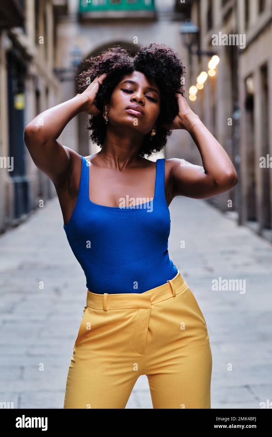 Woman with afro hair posing on the street with her eyes closed Stock ...
