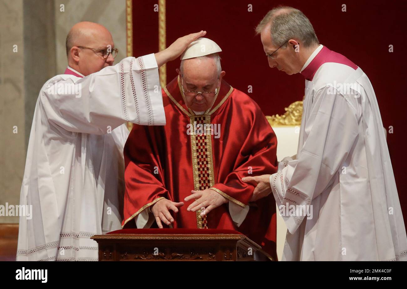 Pope Francis gets his skull cap adjusted as he celebrates Mass for the ...