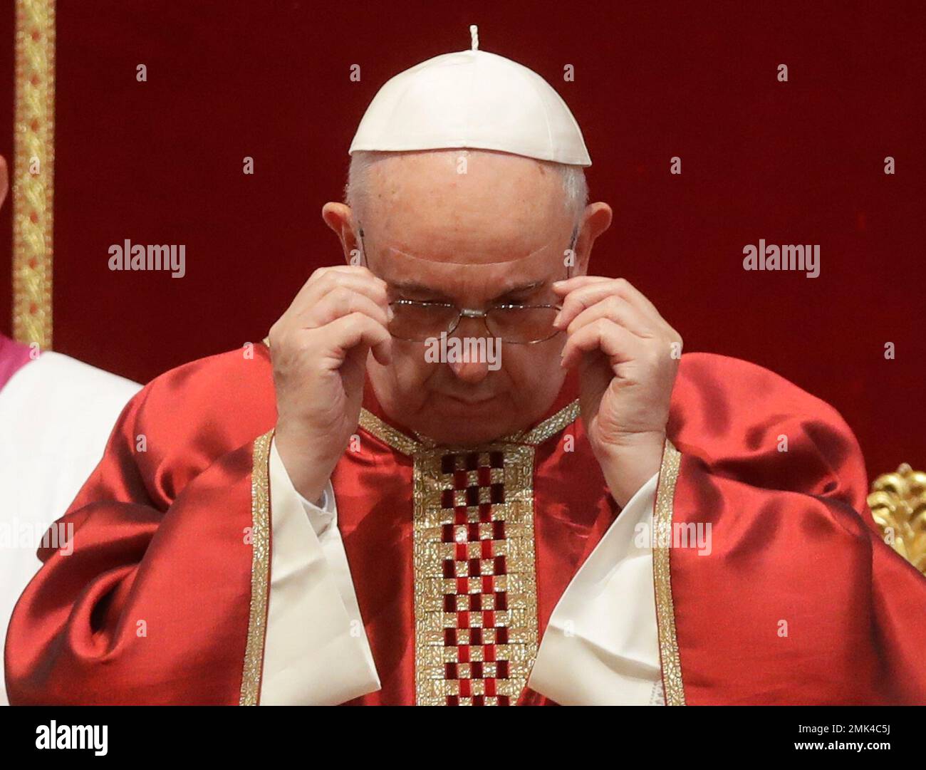 Pope Francis adjusts his glasses as he celebrates Mass for the Passion ...