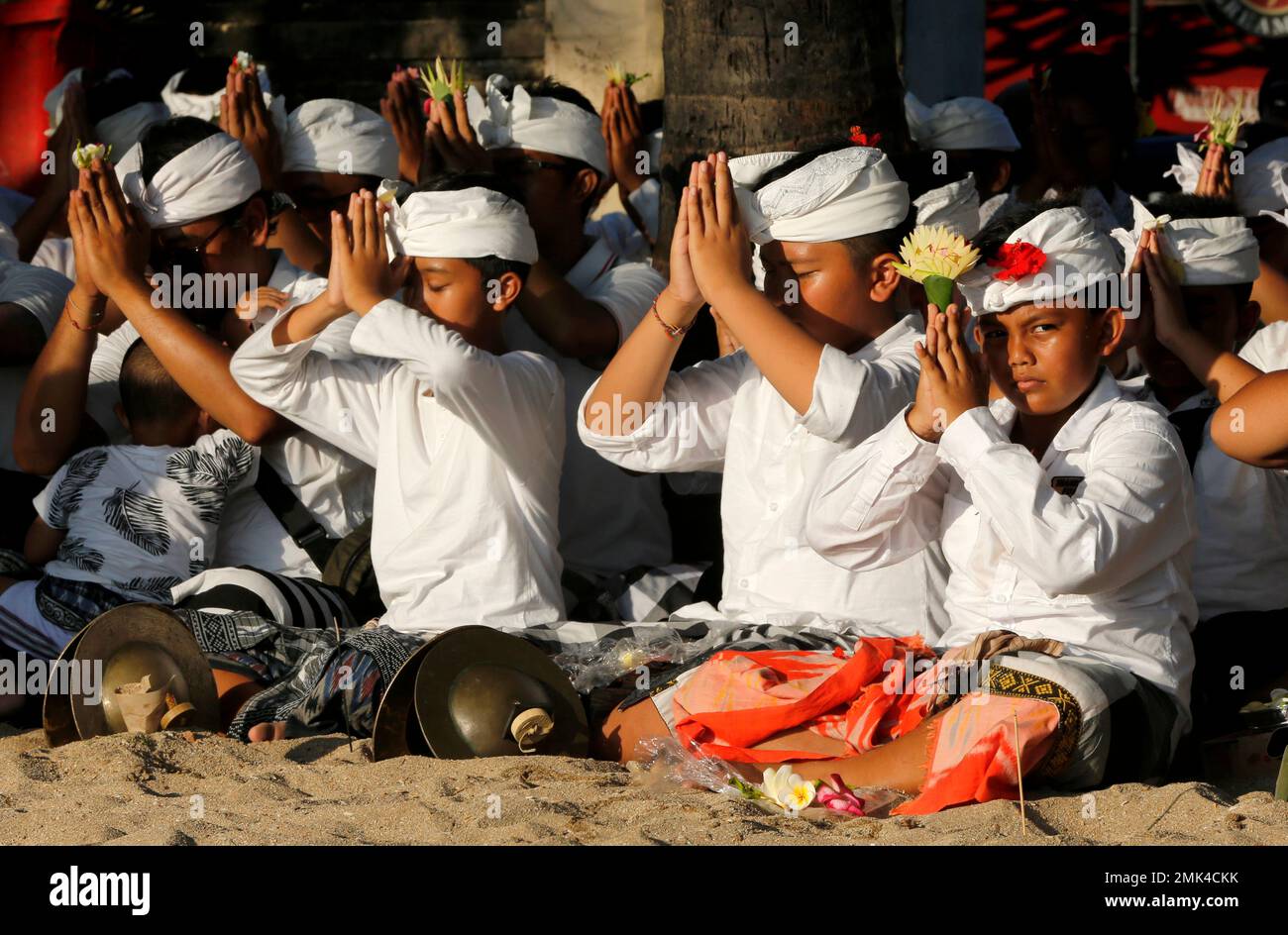 Balinese Hindus pray at a beach during a full moon Hindu ritual in Bali ...