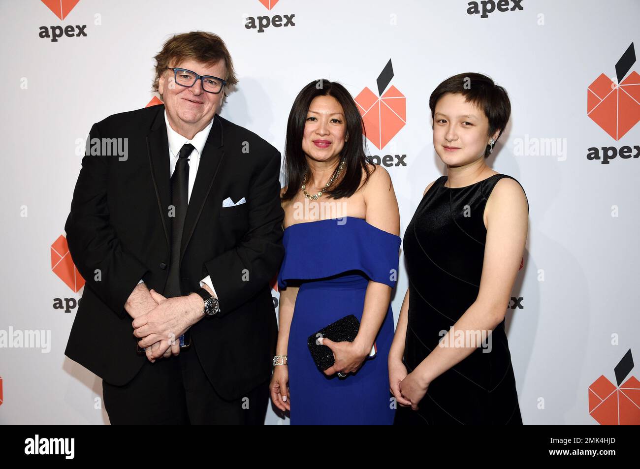 Filmmaker Michael Moore, left, takes a selfie with Sonia Low and ...