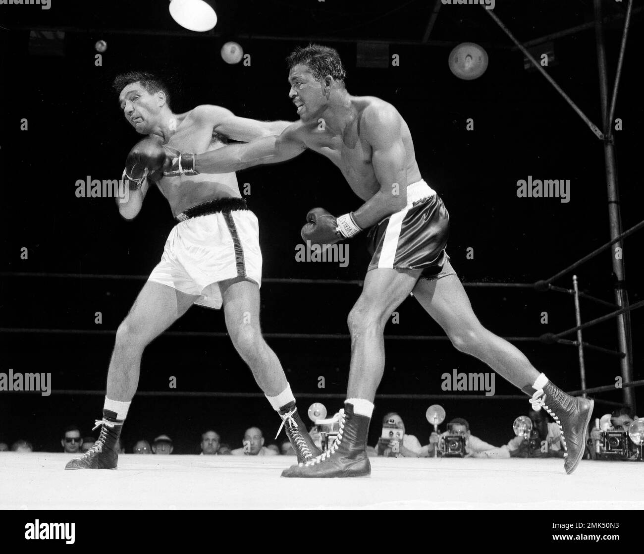 Sugar Ray Robinson jolts Joey Maxim with a right in the third round of ...