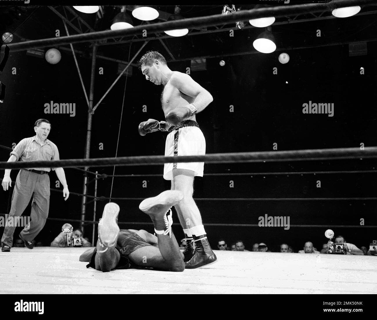 Sugar Ray Robinson sprawls on the canvas in the 13th round of his title ...