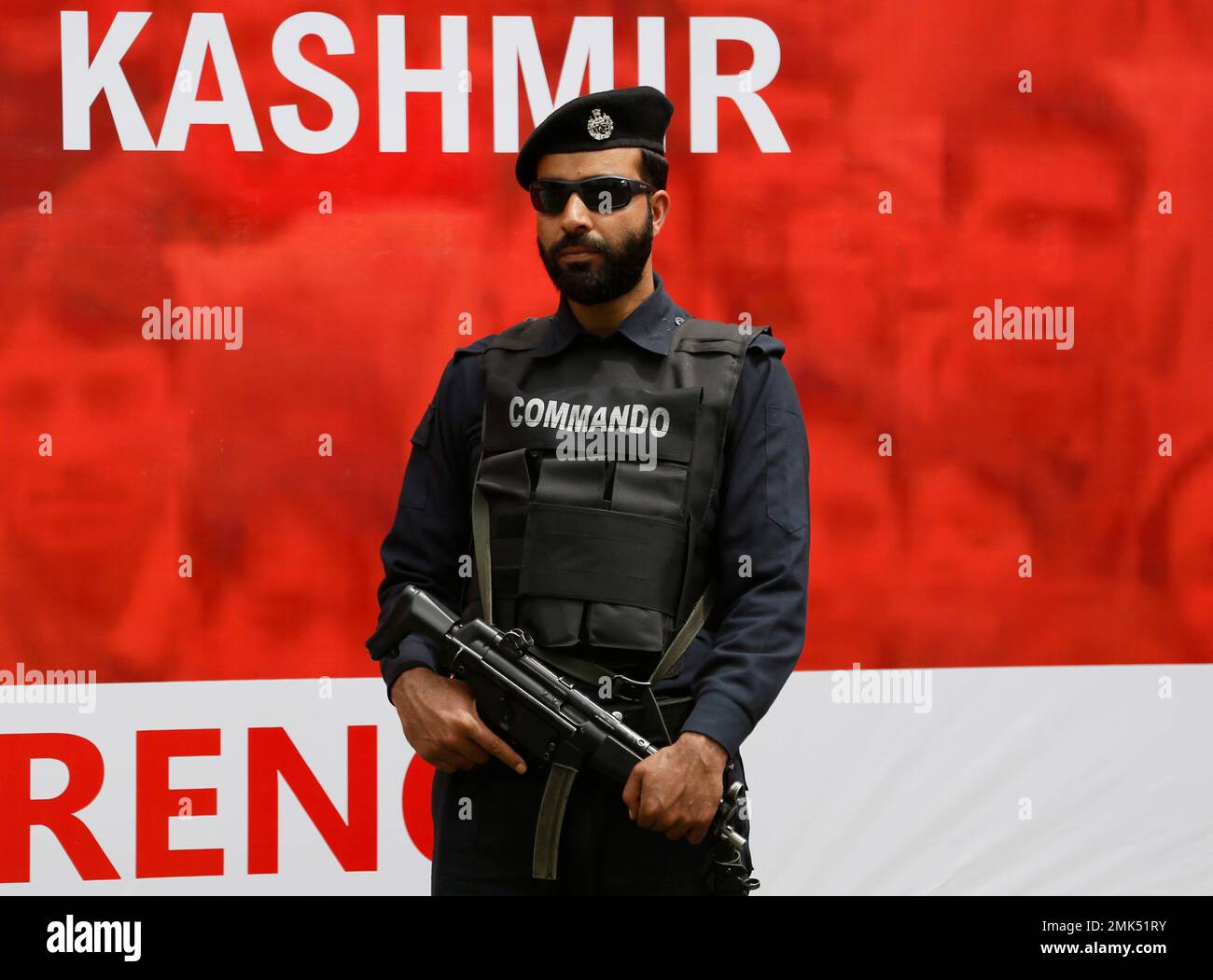 An Indian police commando guards during an election rally in Srinagar ...