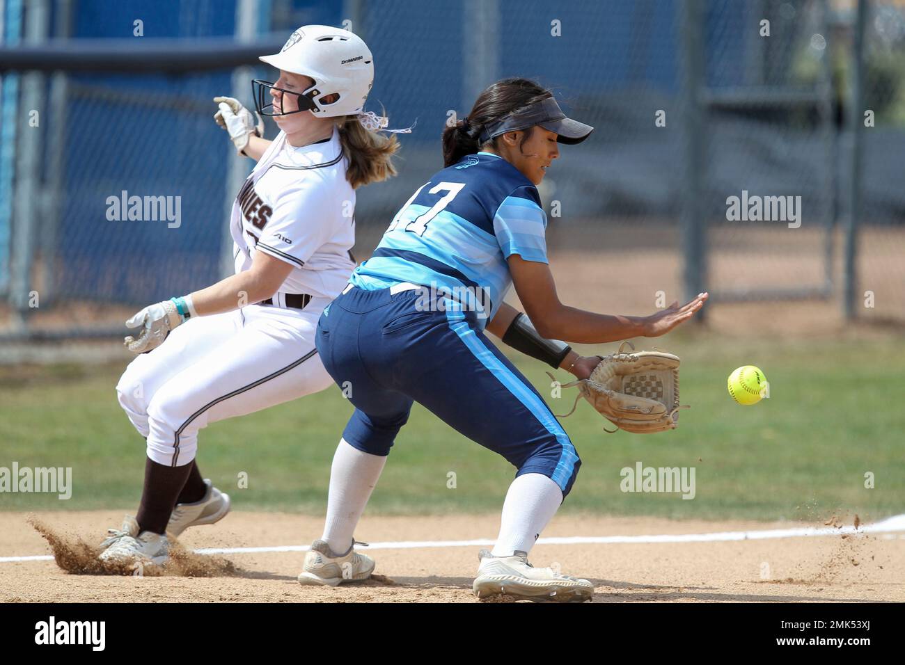 St. Bonaventure's McKenna Holtz, left is safe a third base ahead of a ...