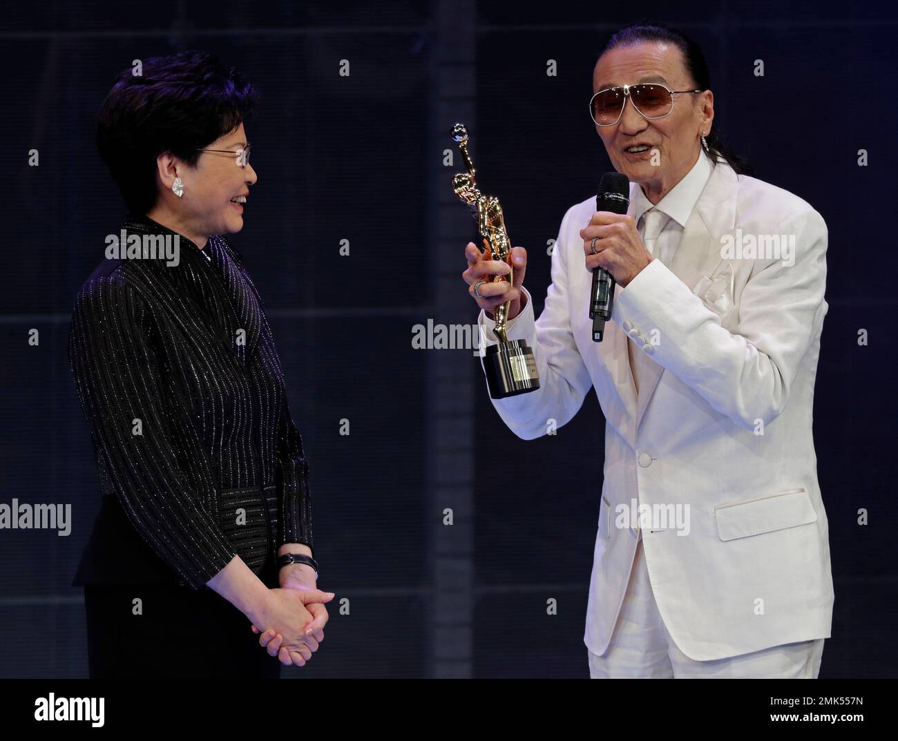Hong Kong actor Patrick Tse, right, reacts after receiving the Lifetime ...