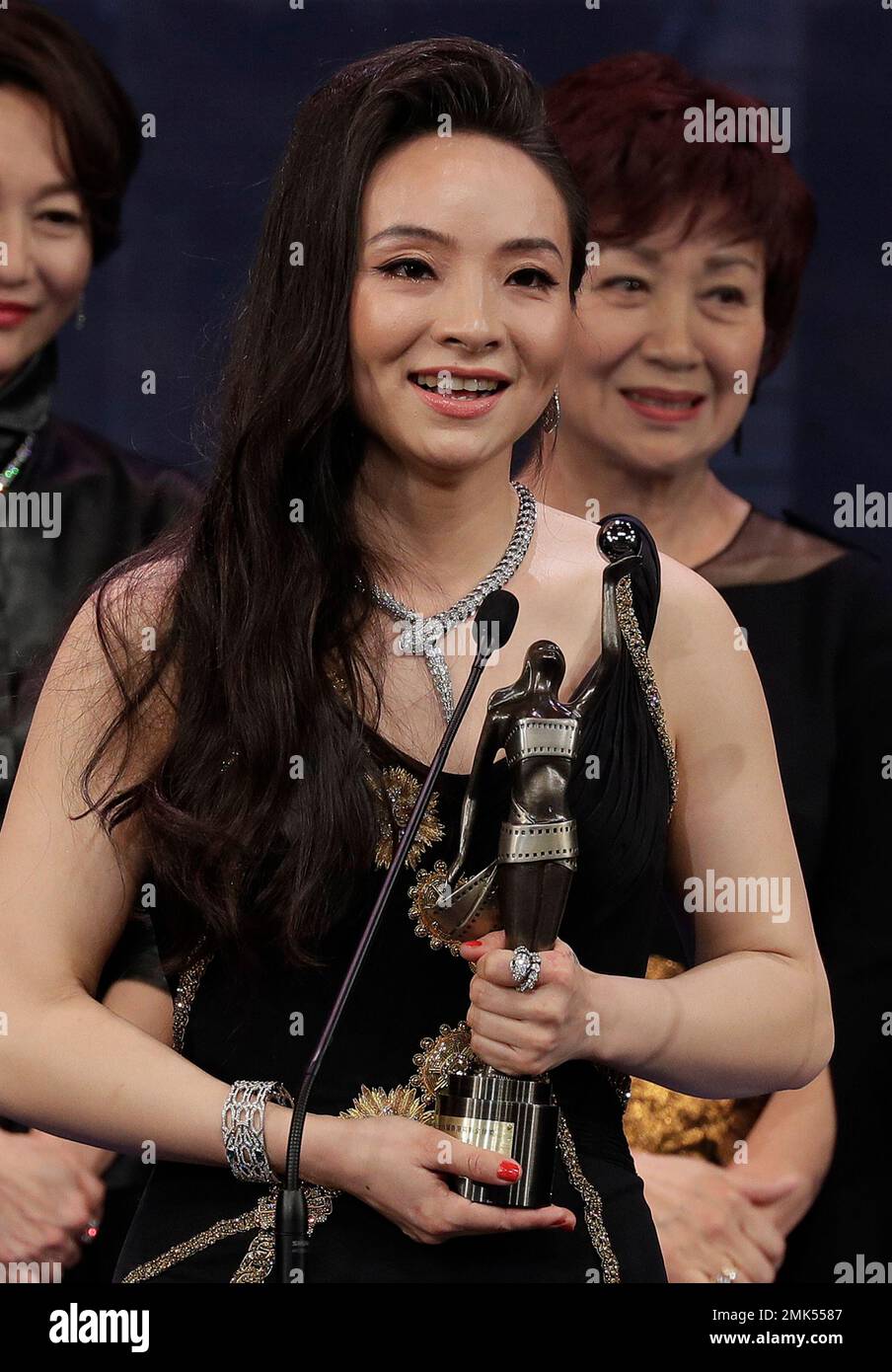Mainland Chinese actress Chloe Maayan holds the trophy after winning ...