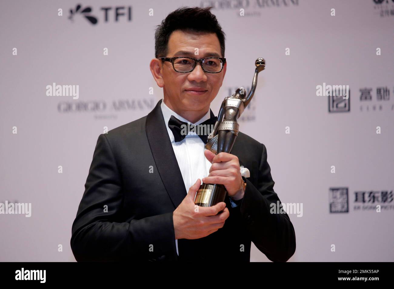 Hong Kong actor Ben Yuen poses for a photograph after winning the Best ...