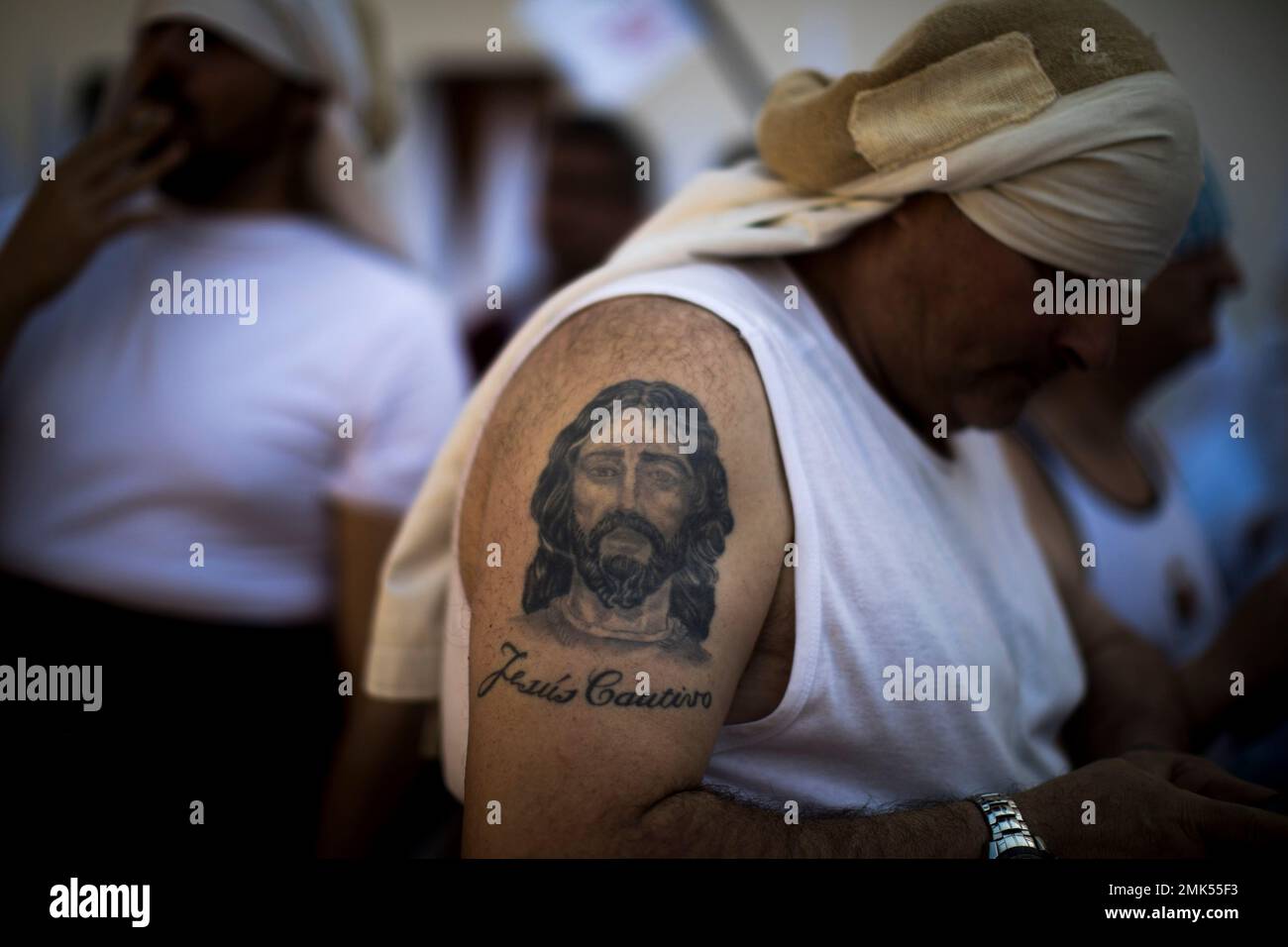 A tattoo of Jesus Christ is seen on the shoulder of Jesus Gallo, 52, a ...
