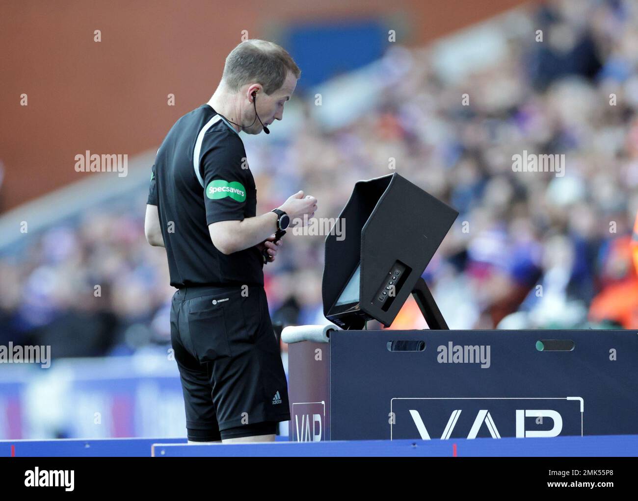 Referee William Collum checks the VAR to overule a decision after ...