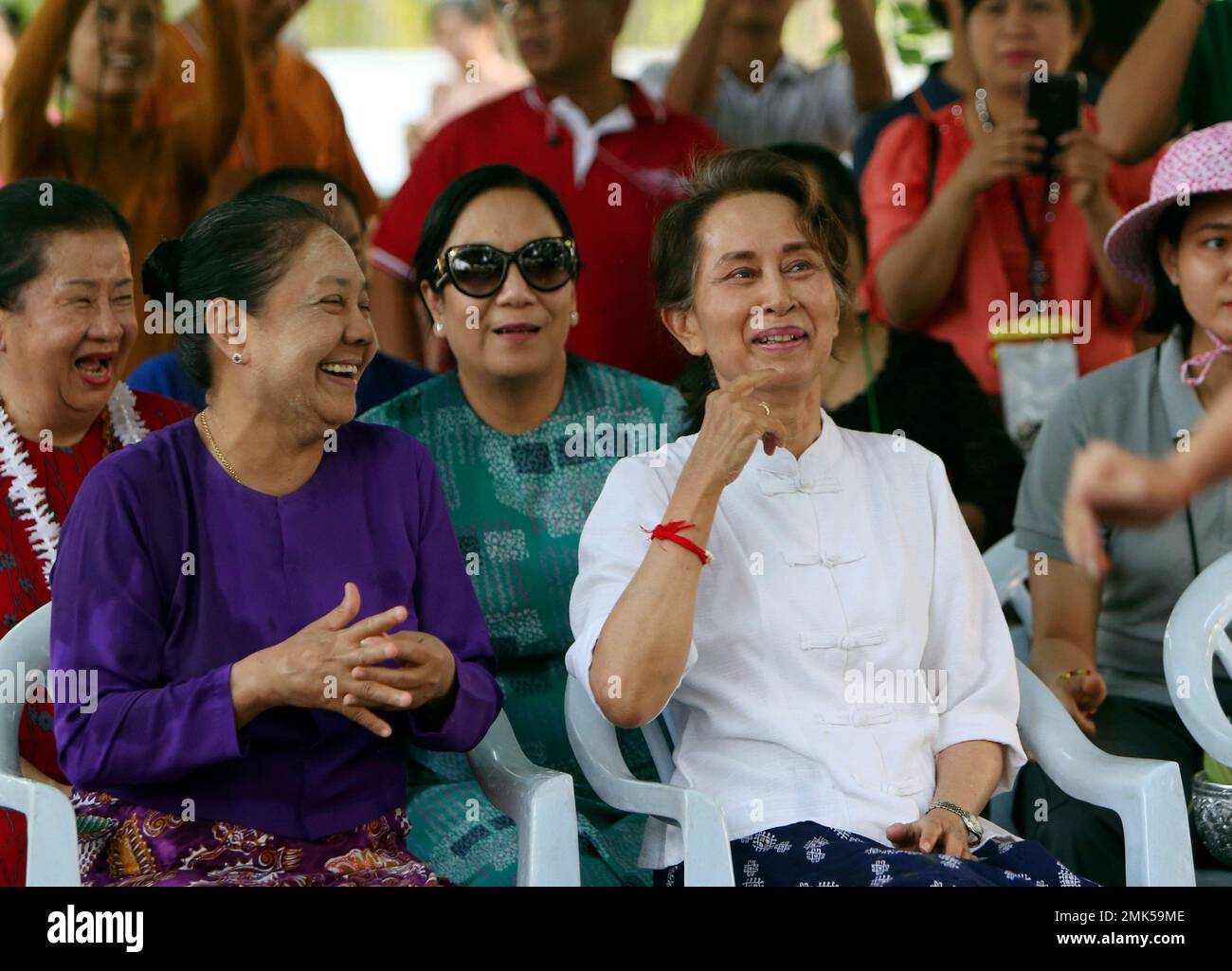 Myanmar's leader Aung San Suu Kyi, right, and first lady Cho Cho, left, smile as they take part ...