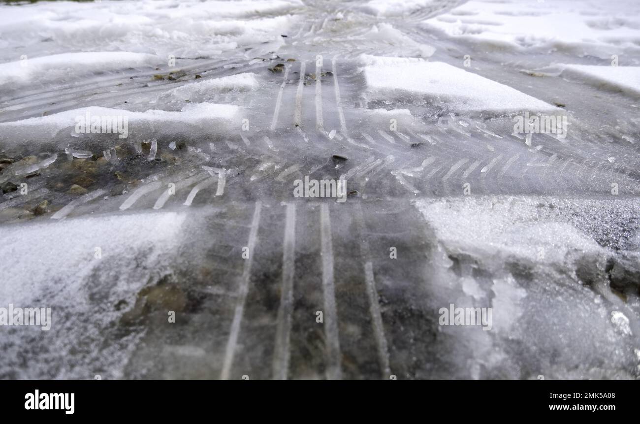 Snowy street with car marks, dangerous and slippery road Stock Photo ...