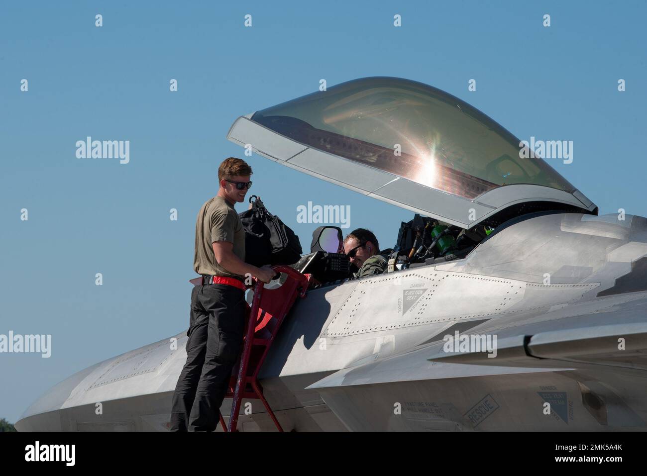 U.S. Air Force Airman 1st Class Isaac Defillipo, left, crew chief ...