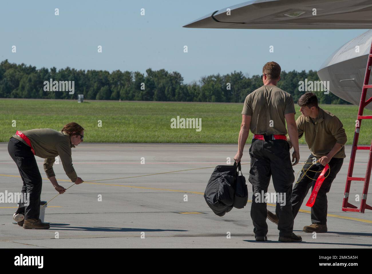 U.S. Air Force Airman 1st Class Caroline Truemper, left, crew chief ...