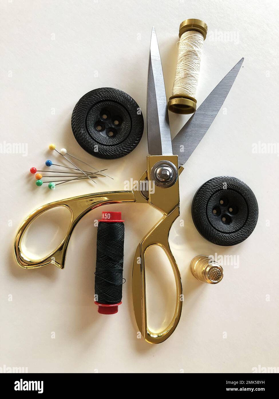 Scissors, threads, pins and buttons on white background Stock Photo - Alamy