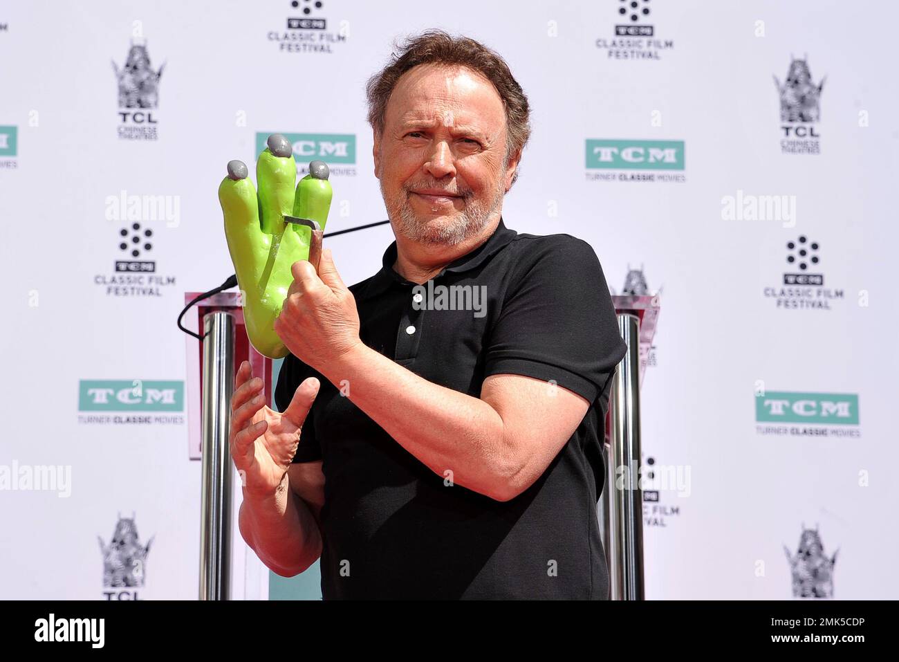 Actor Billy Crystal shows off a foot from his character Mike Wazowski ...
