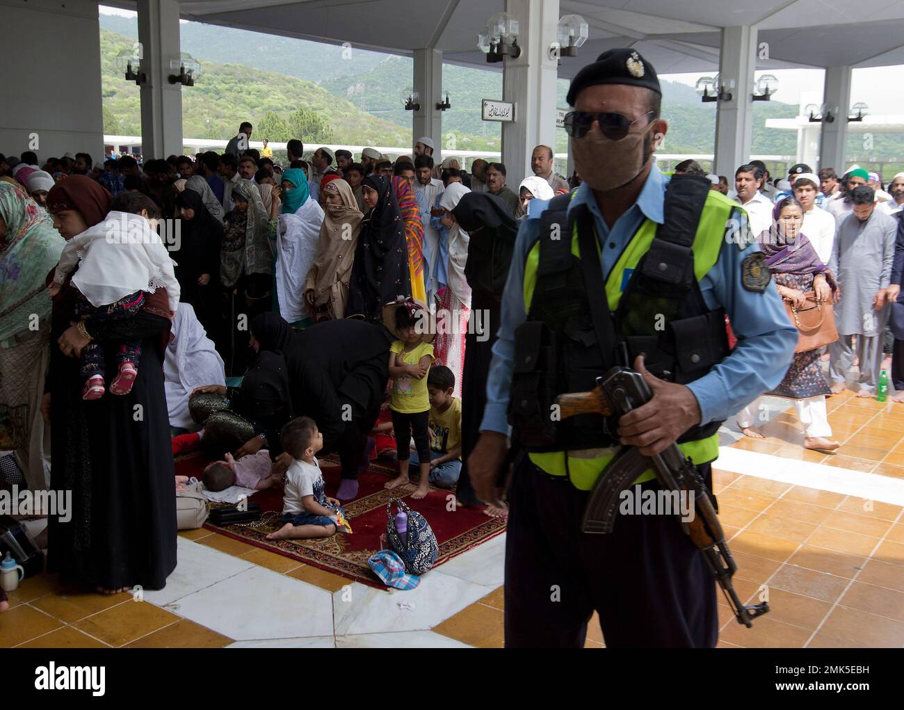 A Pakistani police officer stands guard during Friday prayers led by ...