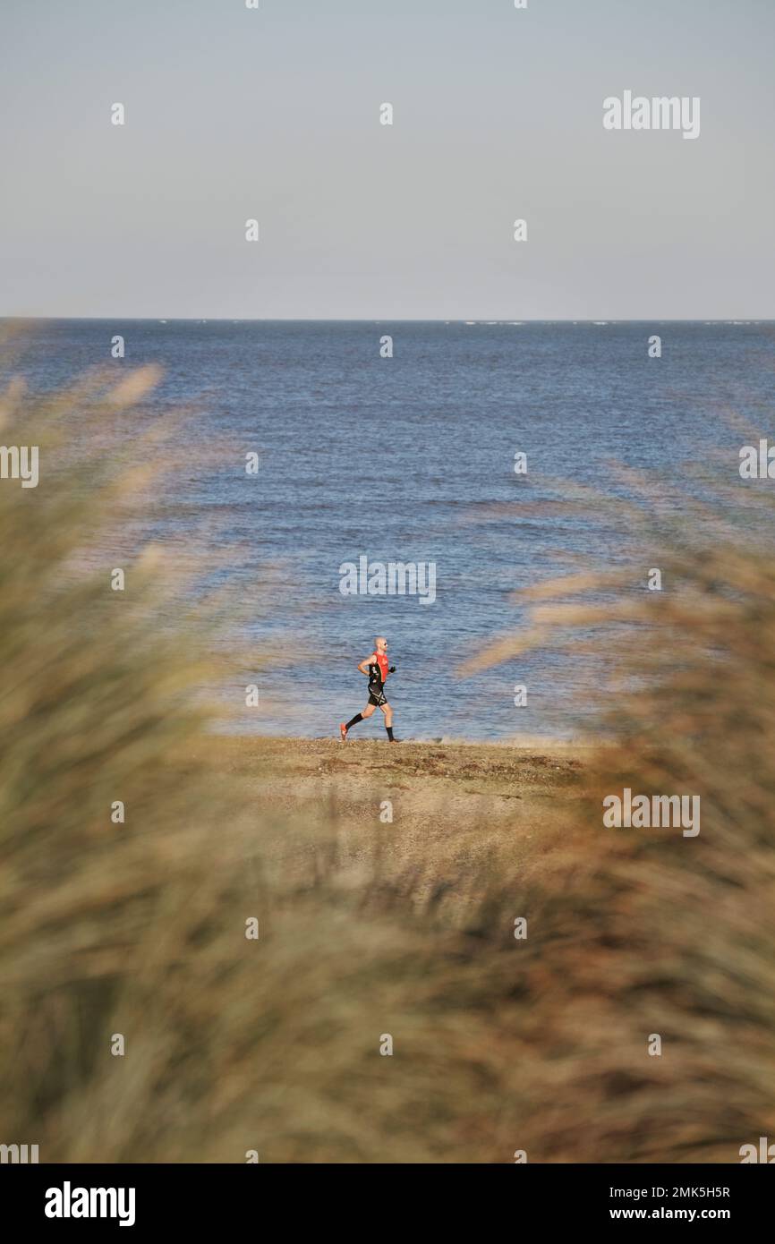 lone runner on beach at caister on sea norfolk england Stock Photo - Alamy