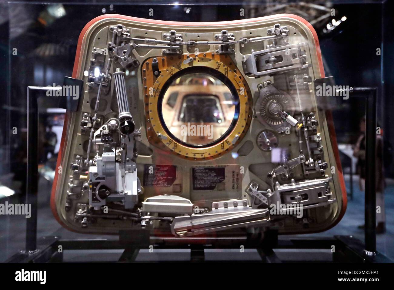 The hatch of the NASA Apollo 11 command module Columbia is displayed behind glass in front of ...