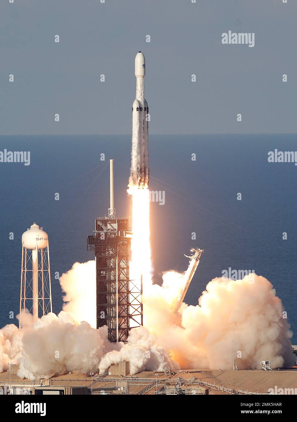 A SpaceX Falcon Heavy rocket carrying a communication satellite lifts ...