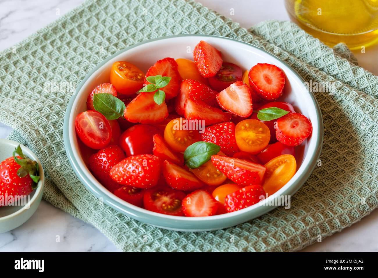 homemade strawberry, tomato cherry and basil leaves salad served in a ...