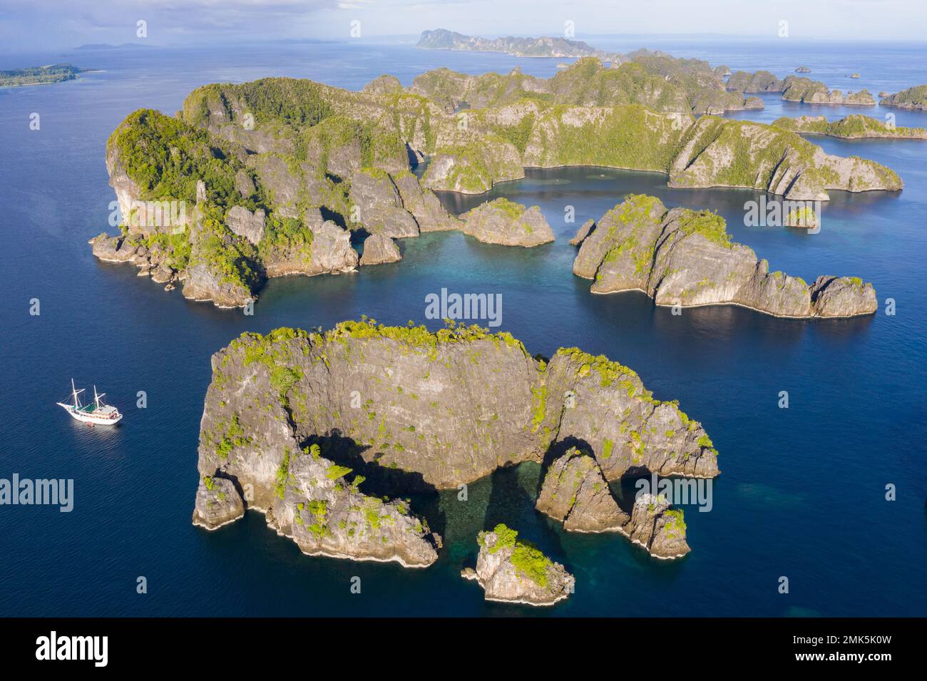 Rock islands, composed of limestone, rise from the tropical seascape in ...